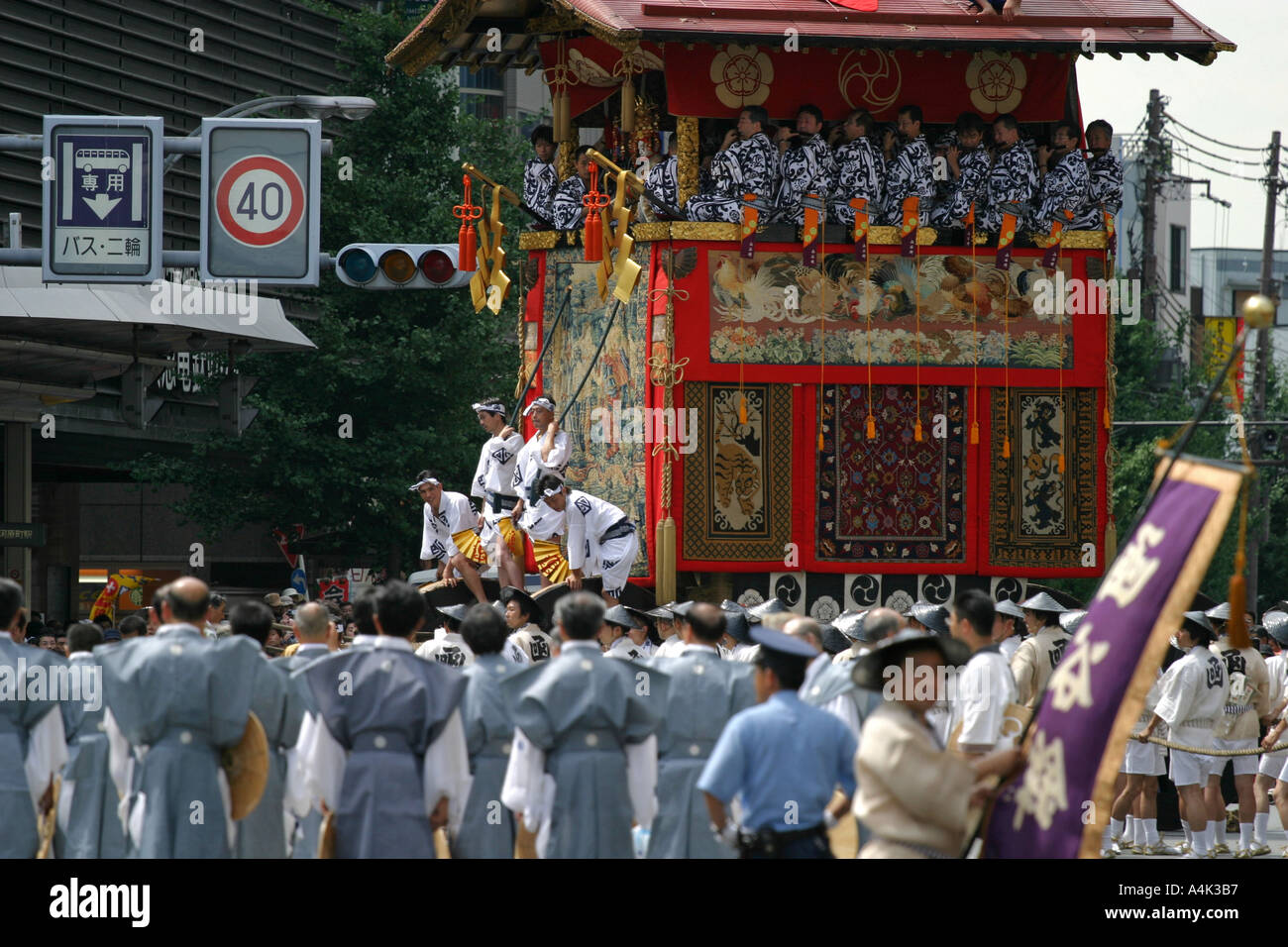 A gion Matsuri festival float is pulled through the modern day streets ...