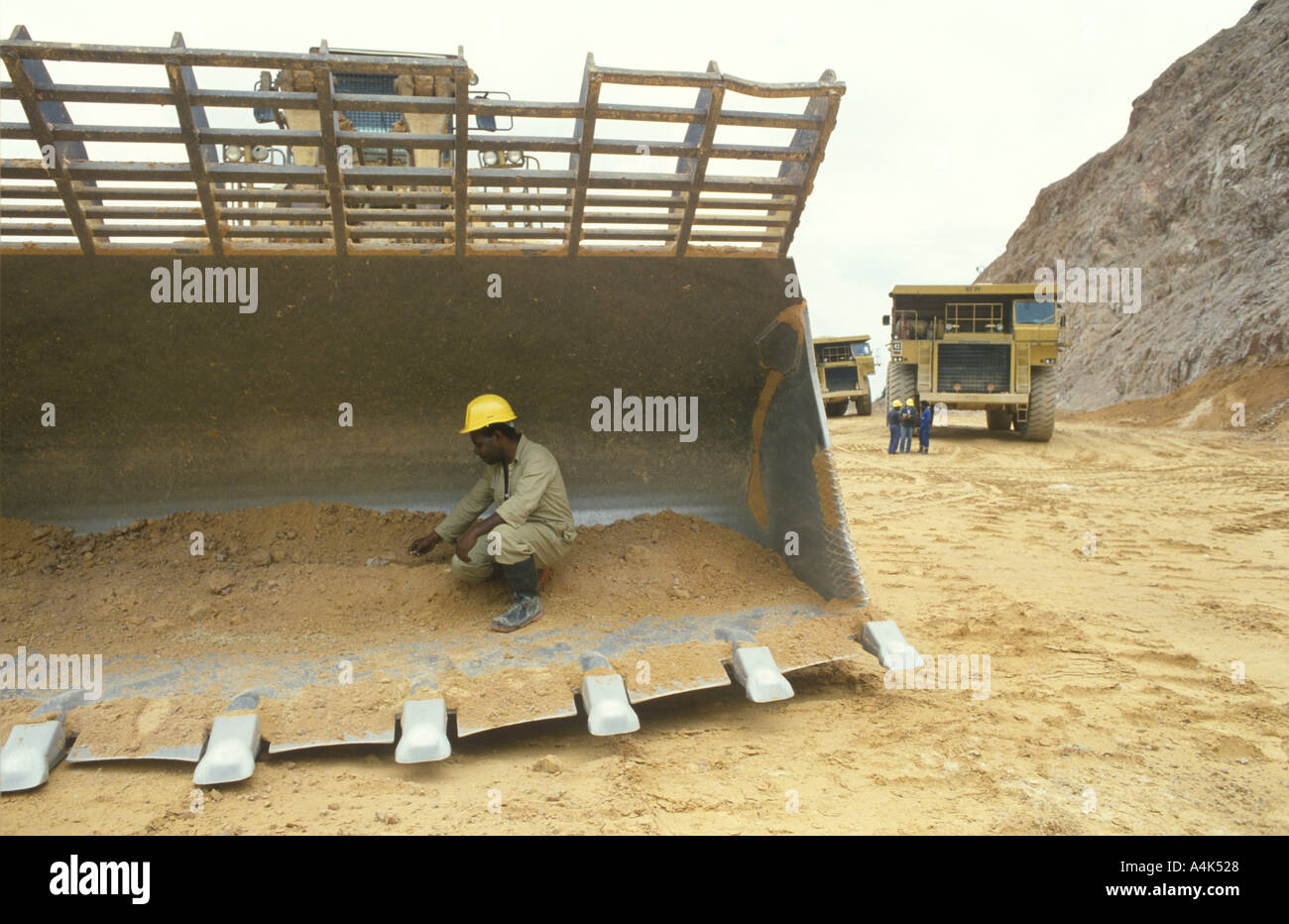 man in shovel of gigantic front end loader in mine Stock Photo - Alamy