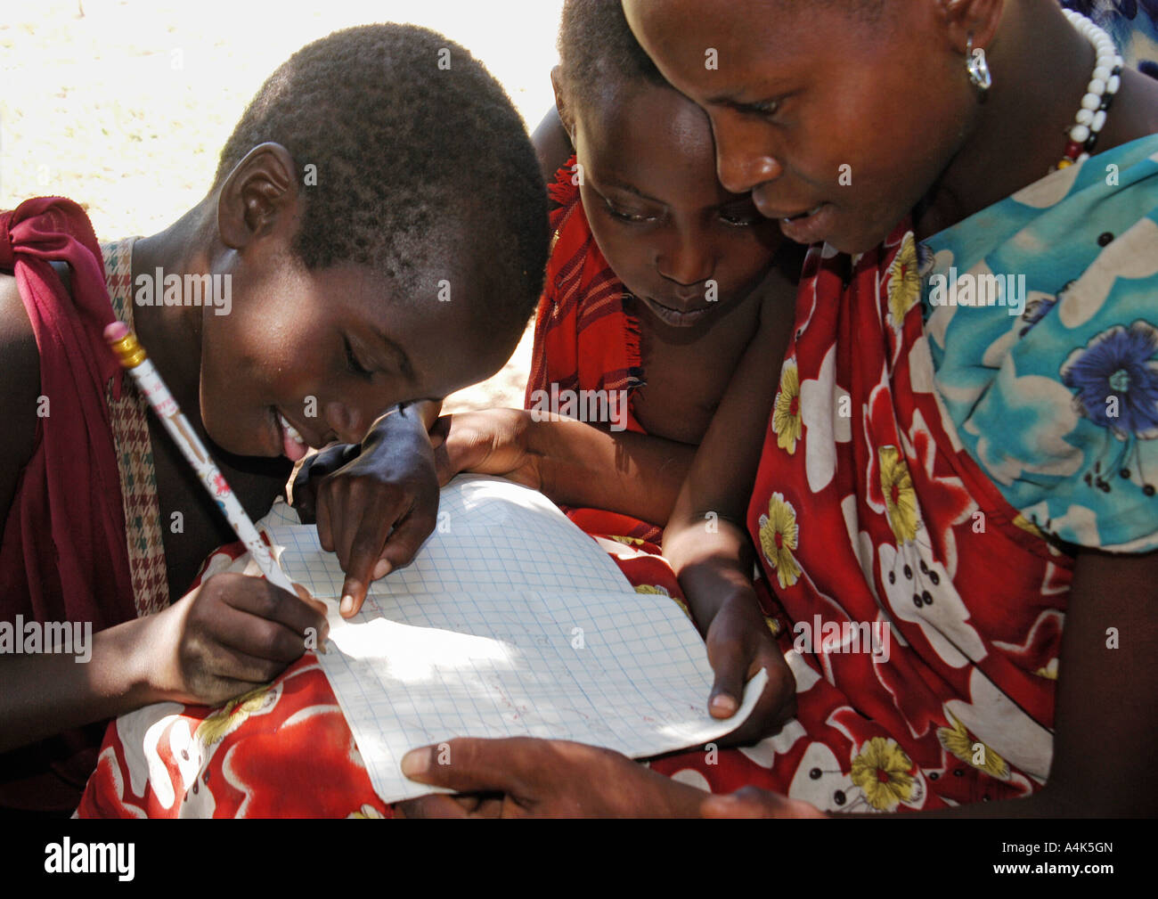 Children helping each other study hi-res stock photography and images ...