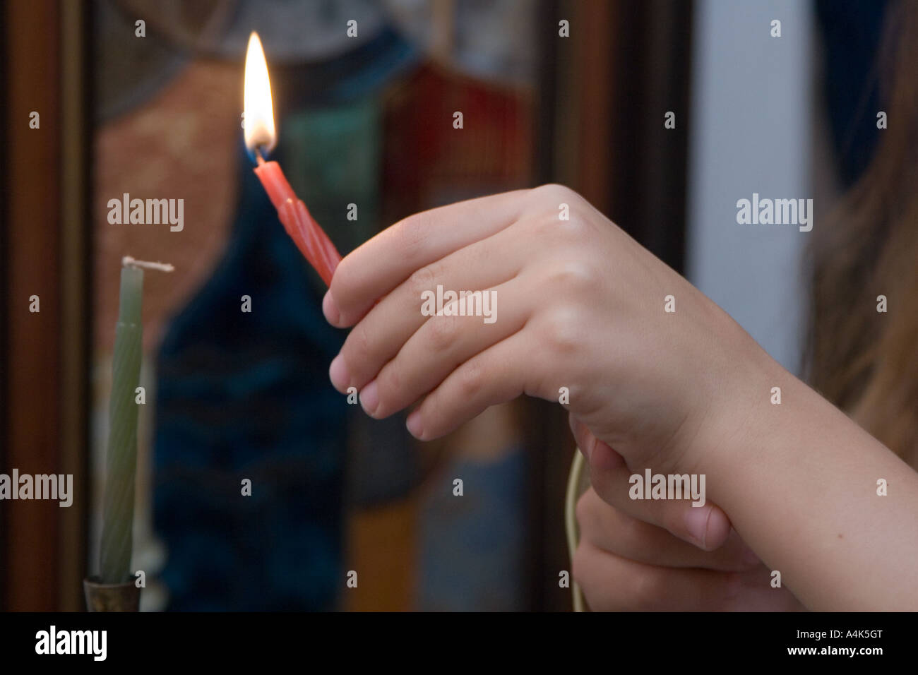 Stock Photo of Small Hands Lighting a Menorah on The First Night of The ...