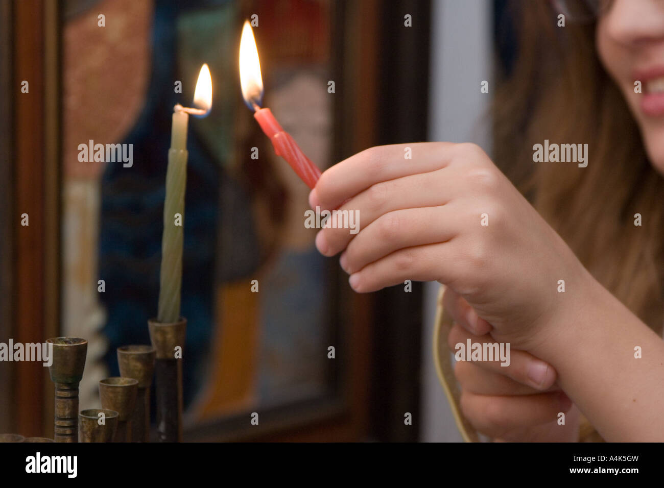 Stock Photo of Small Hands Lighting a Menorah on The First Night of The ...