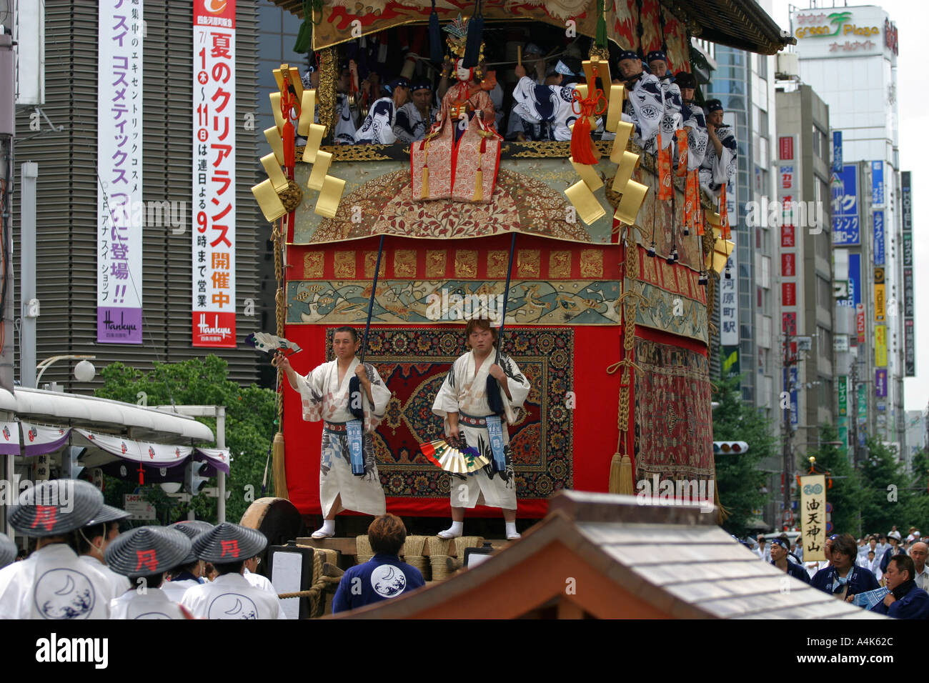 Men dance on a colourful festival float at the Gion Matsuri in Kyoto ...