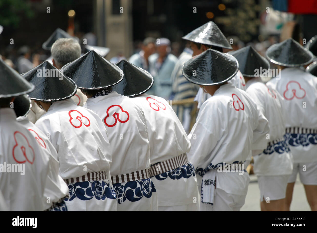 Men in period costumes pull and heave a festival float during the Gion ...