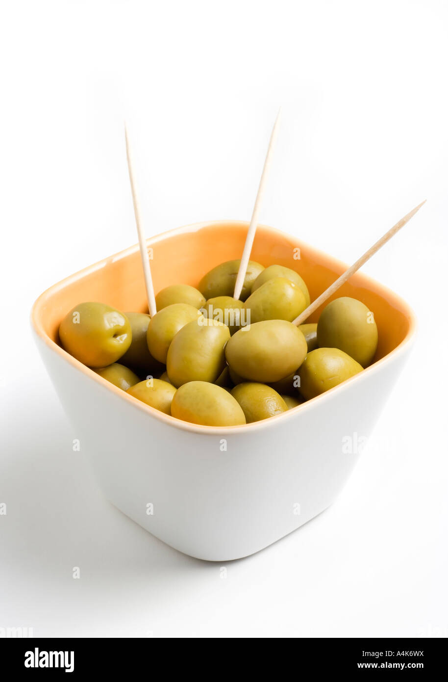 A cup of green olives isolated on a white background Stock Photo - Alamy