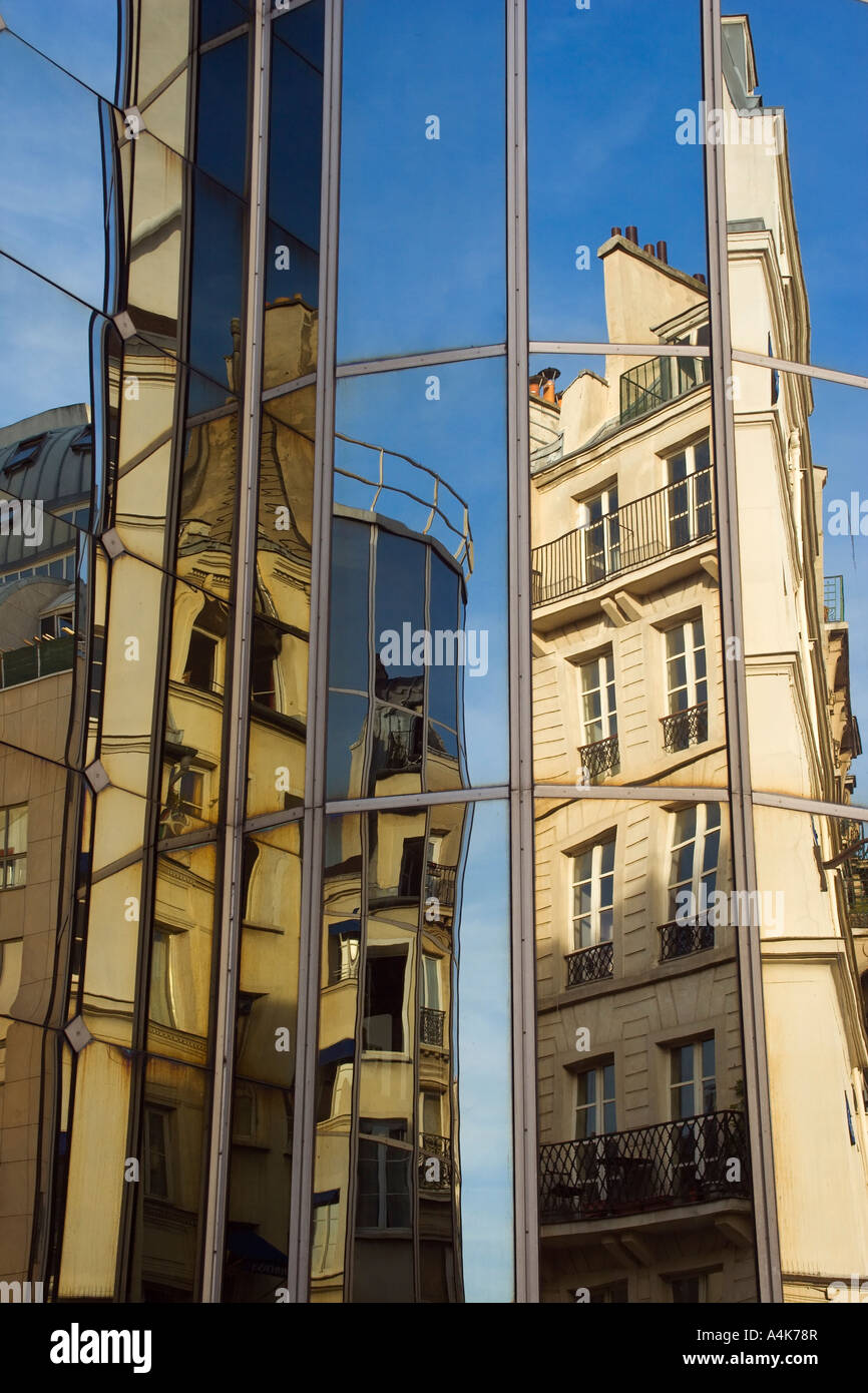 Typical parisian building reflecting in a modern glass building's ...