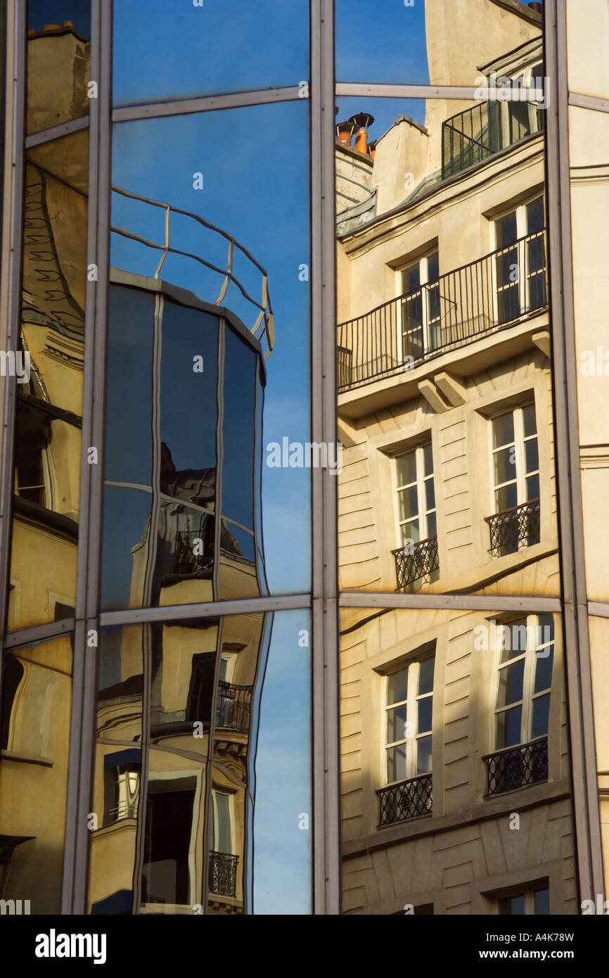 Typical parisian building reflecting in a modern glass building's ...
