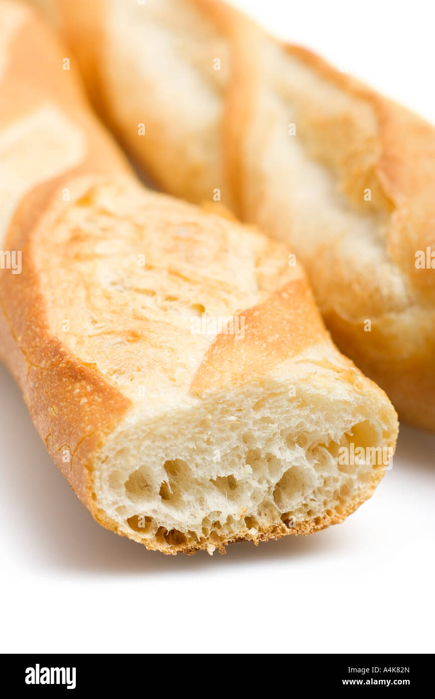 Closeup view of two french bread baguettes on a white background ...