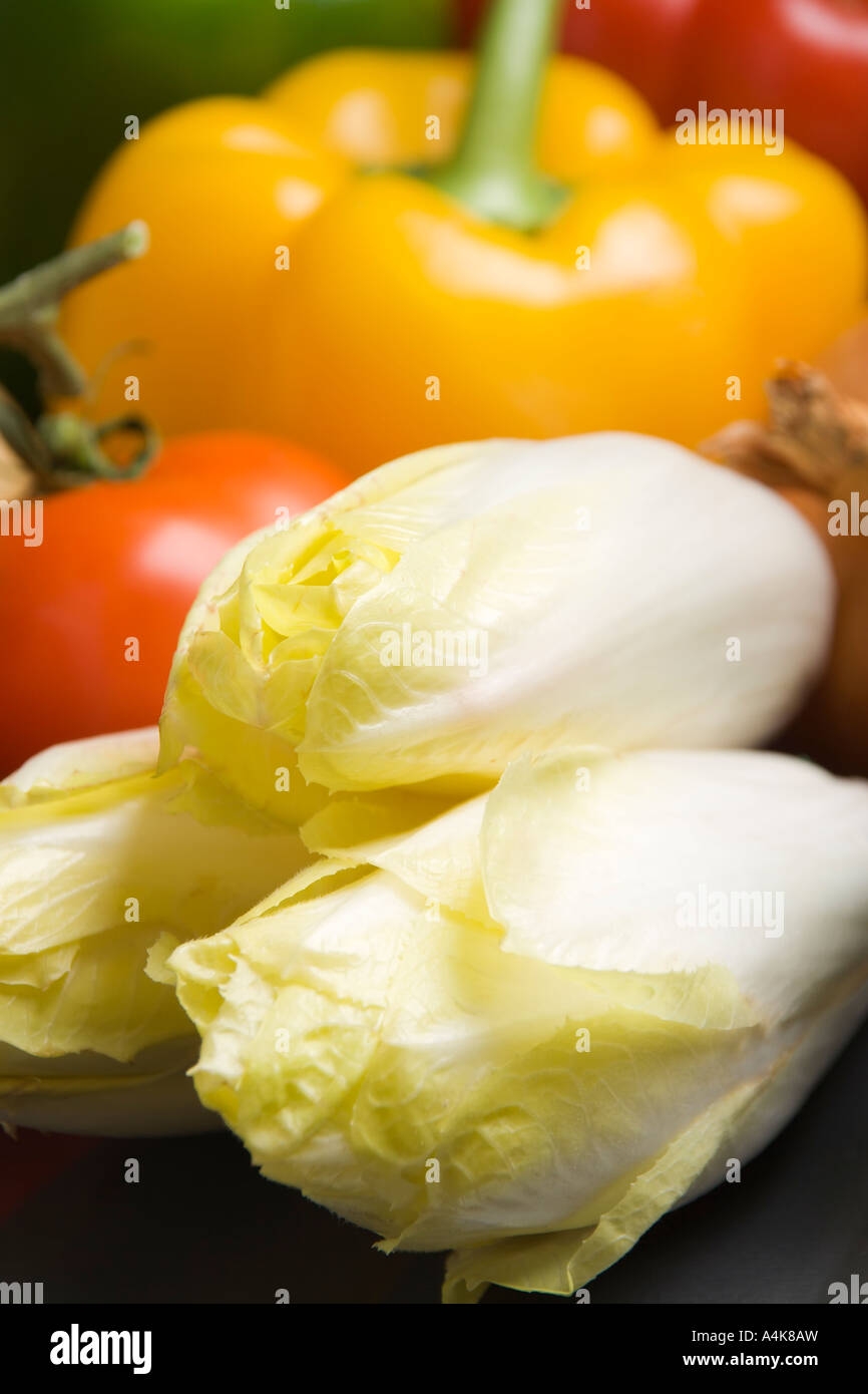 Closeup view of fresh endives in front of other vegetables (shallow DOF ...