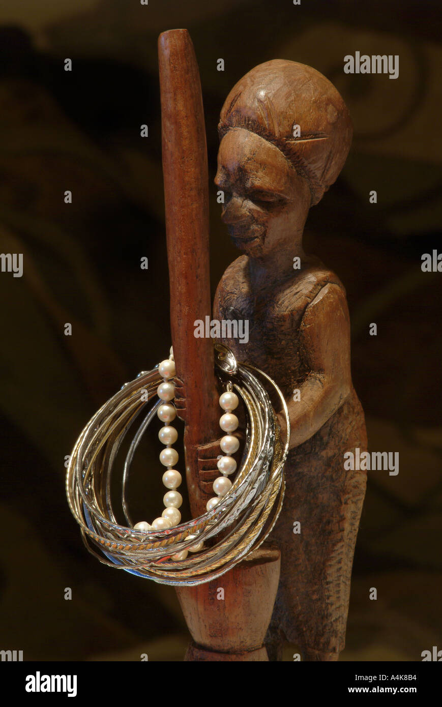 bangles and bracelets on African carving Stock Photo - Alamy