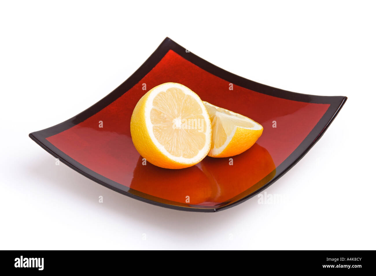 Two lemon slices in a red lacquered plate on a white background Stock ...