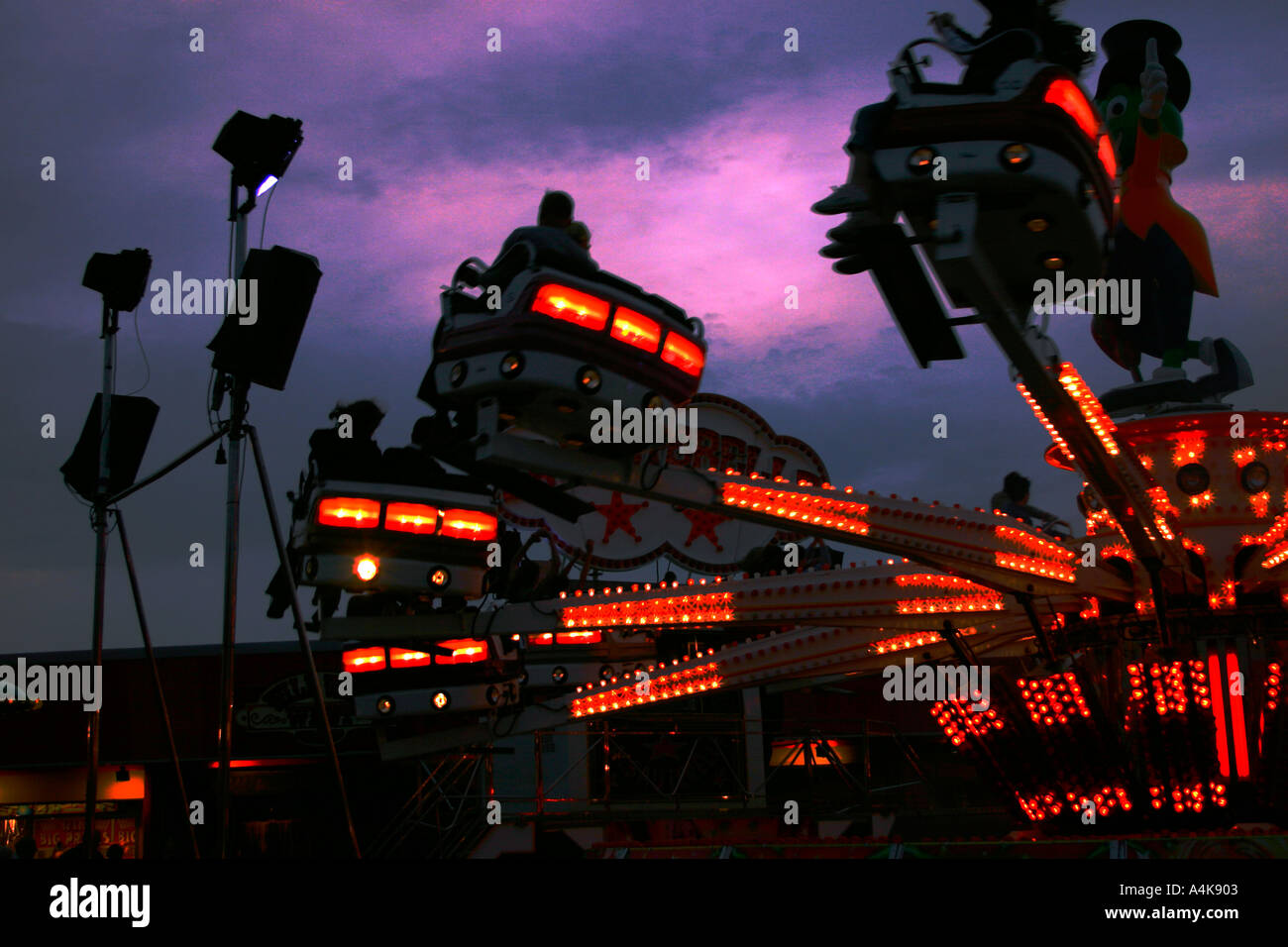 Atmospheric futuristic ghostly fun fair ride at night Stock Photo - Alamy