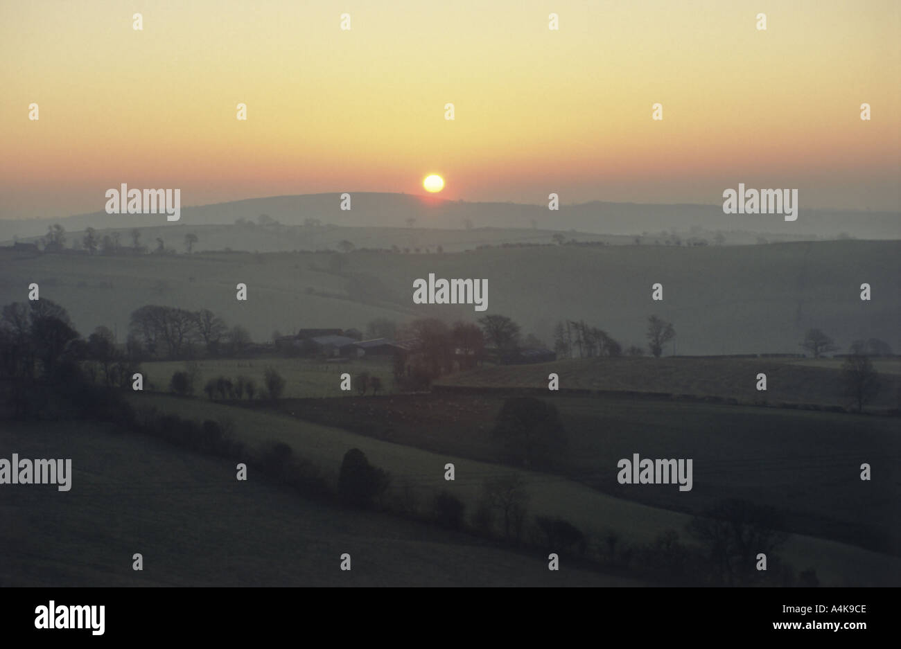 Sunrise English countryside in mist early morning UK Stock Photo - Alamy