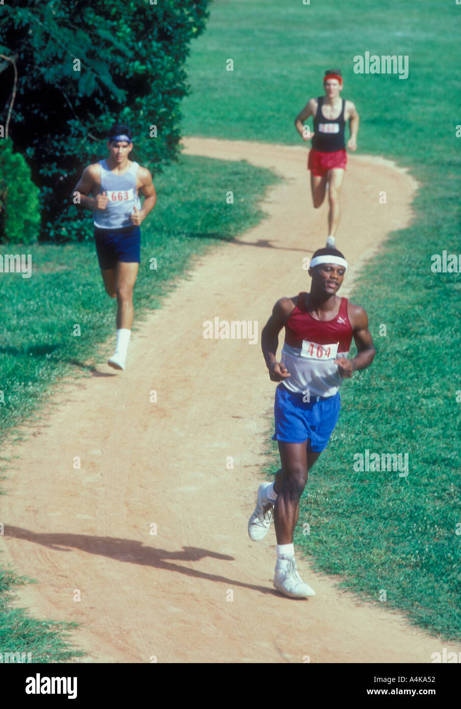three men running on college track Stock Photo - Alamy