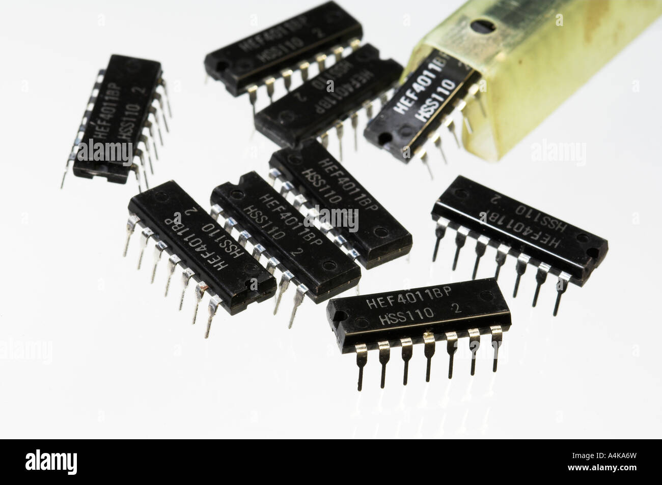 Closeup CMOS integrated circuit chips spilling out of anti static tube ...