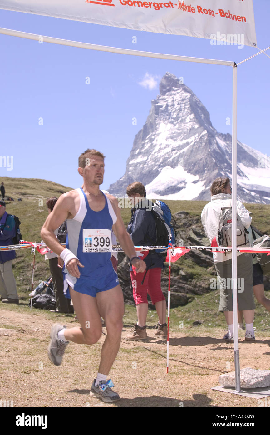 a runner finnishing the Zermatt marathon in front of the Matterhorn ...