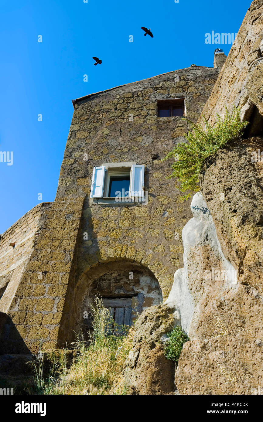 House built on a tuff rock in Calcata, medieval town in the river Treia ...