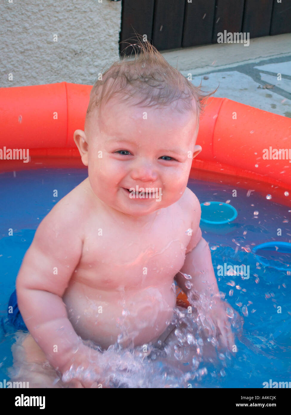 Fun in the paddling pool Stock Photo - Alamy