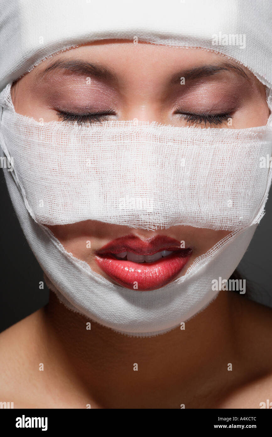 Woman with bandages on her face Stock Photo - Alamy