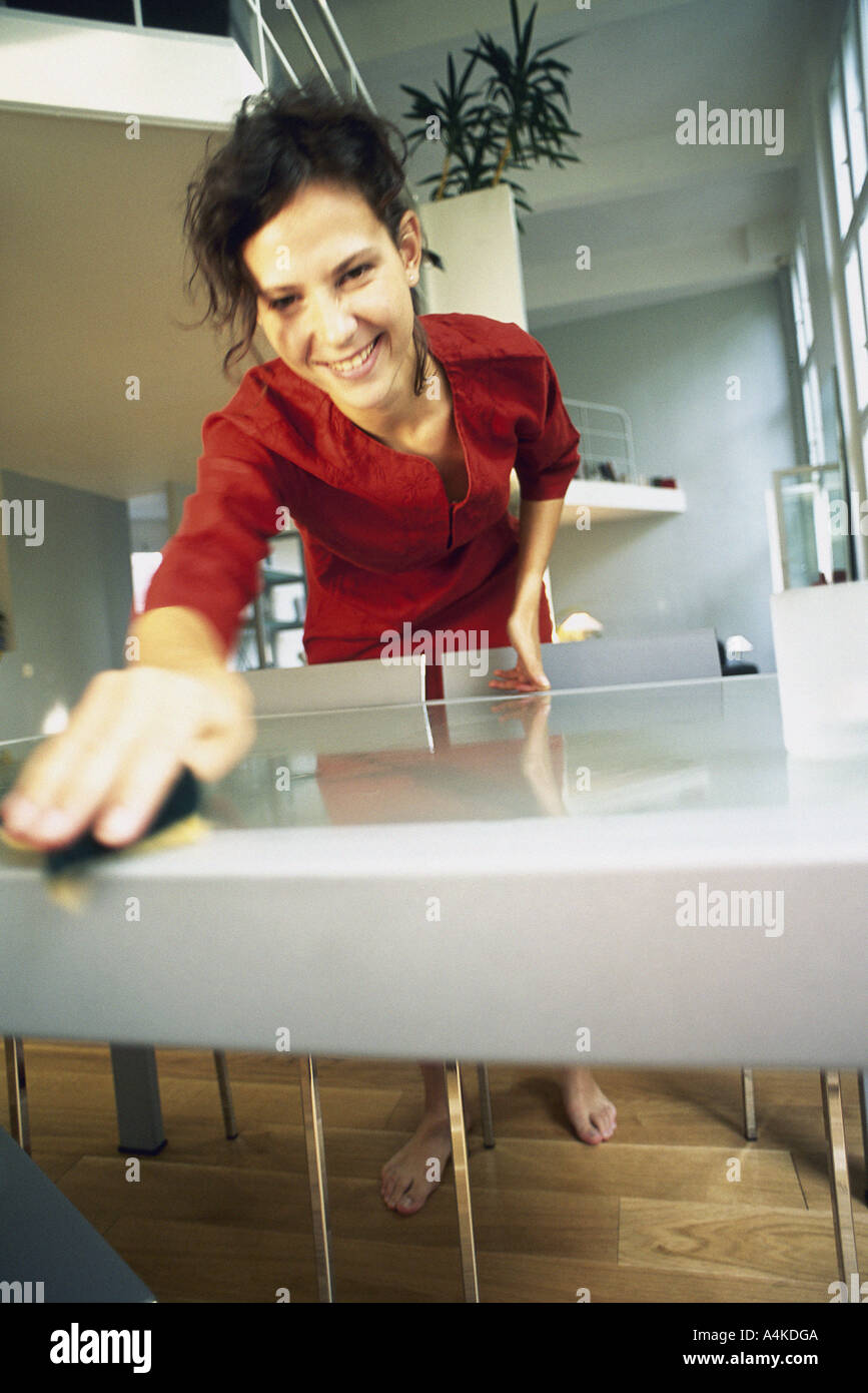 Woman cleaning table Stock Photo - Alamy