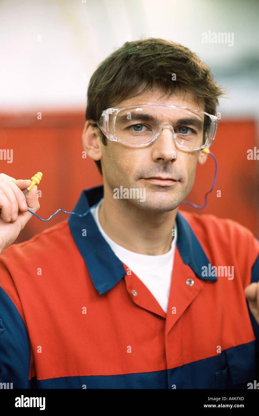 Manual worker wearing safety goggles Stock Photo - Alamy