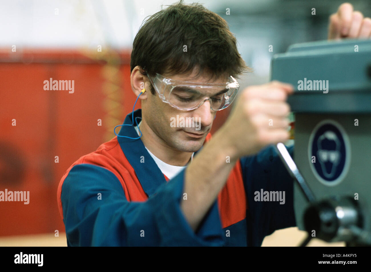 Manual worker using drill machine Stock Photo - Alamy