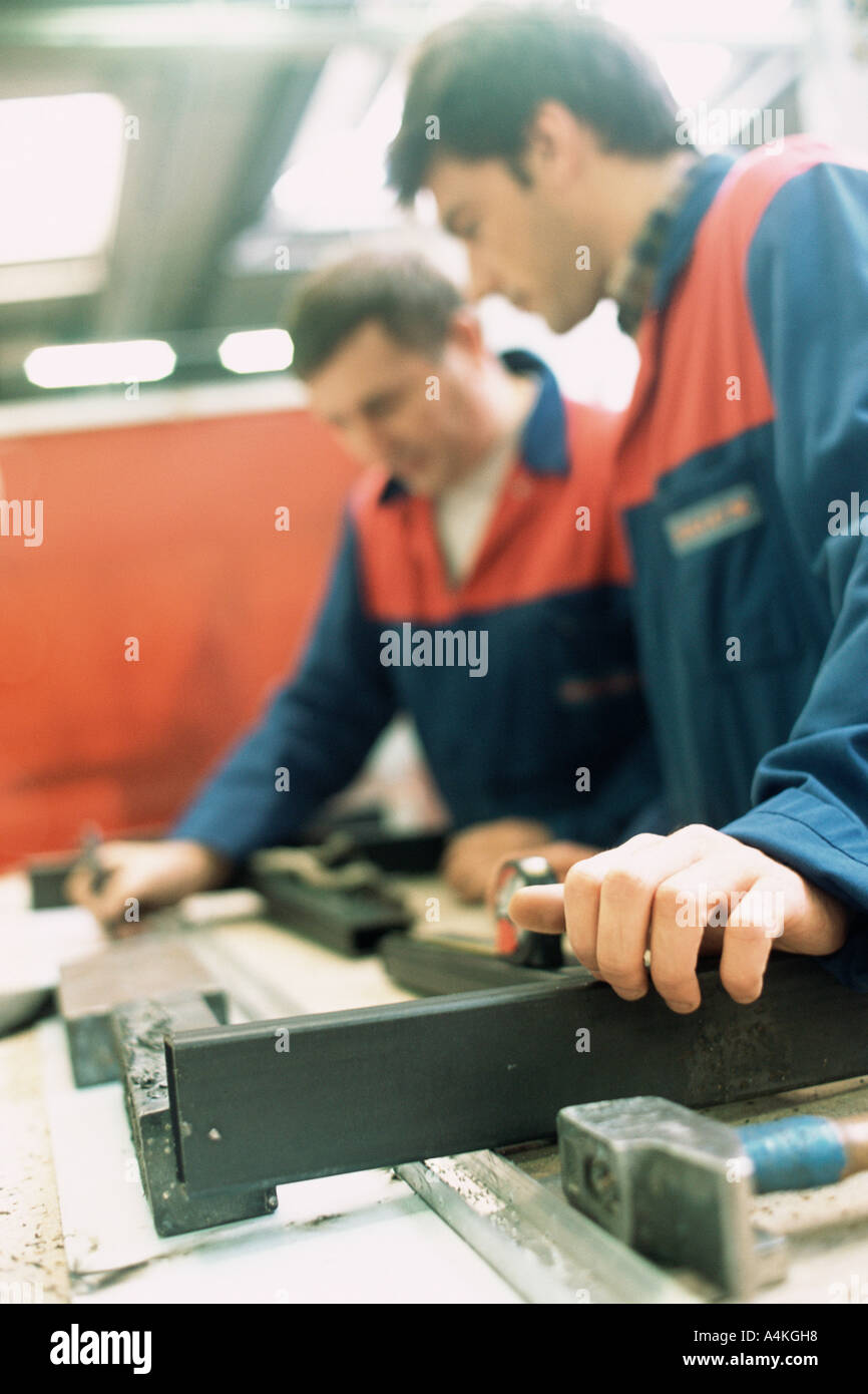 Manual worker and apprentice Stock Photo - Alamy