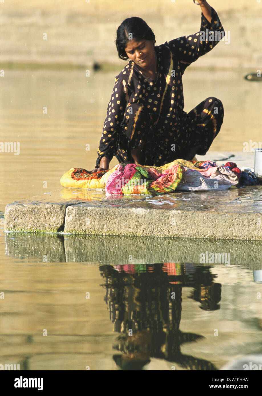 India, Sarkej, woman washing clothes by river Stock Photo - Alamy