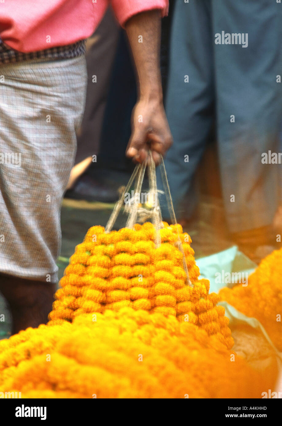 India, man carrying marigold garlands Stock Photo - Alamy
