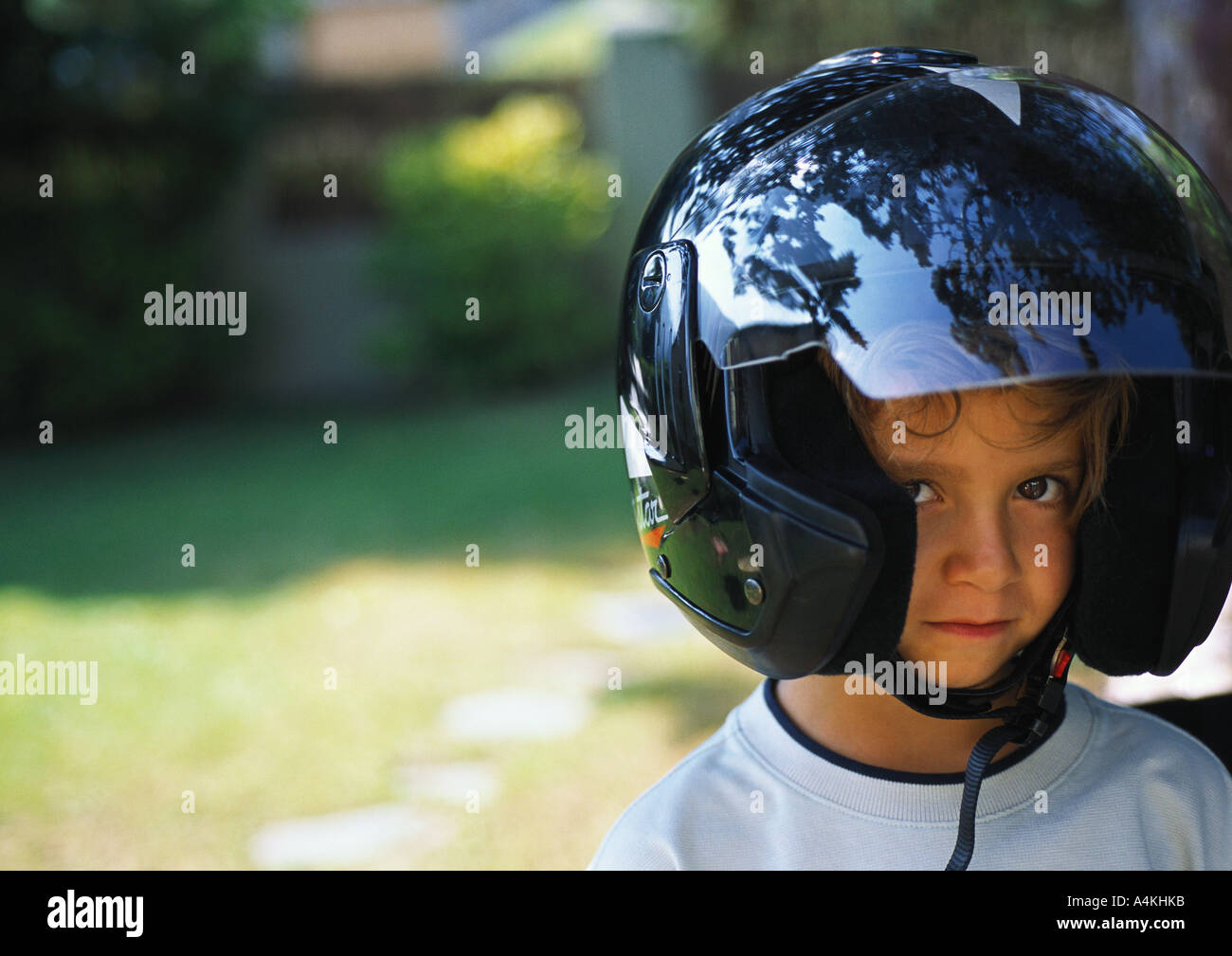 Girl wearing over-sized helmet Stock Photo - Alamy