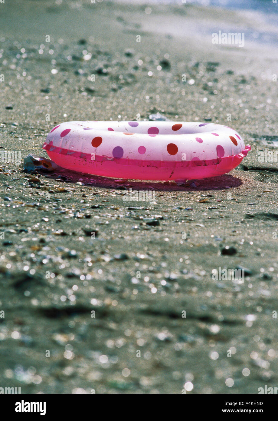 Inflatable ring on beach Stock Photo - Alamy