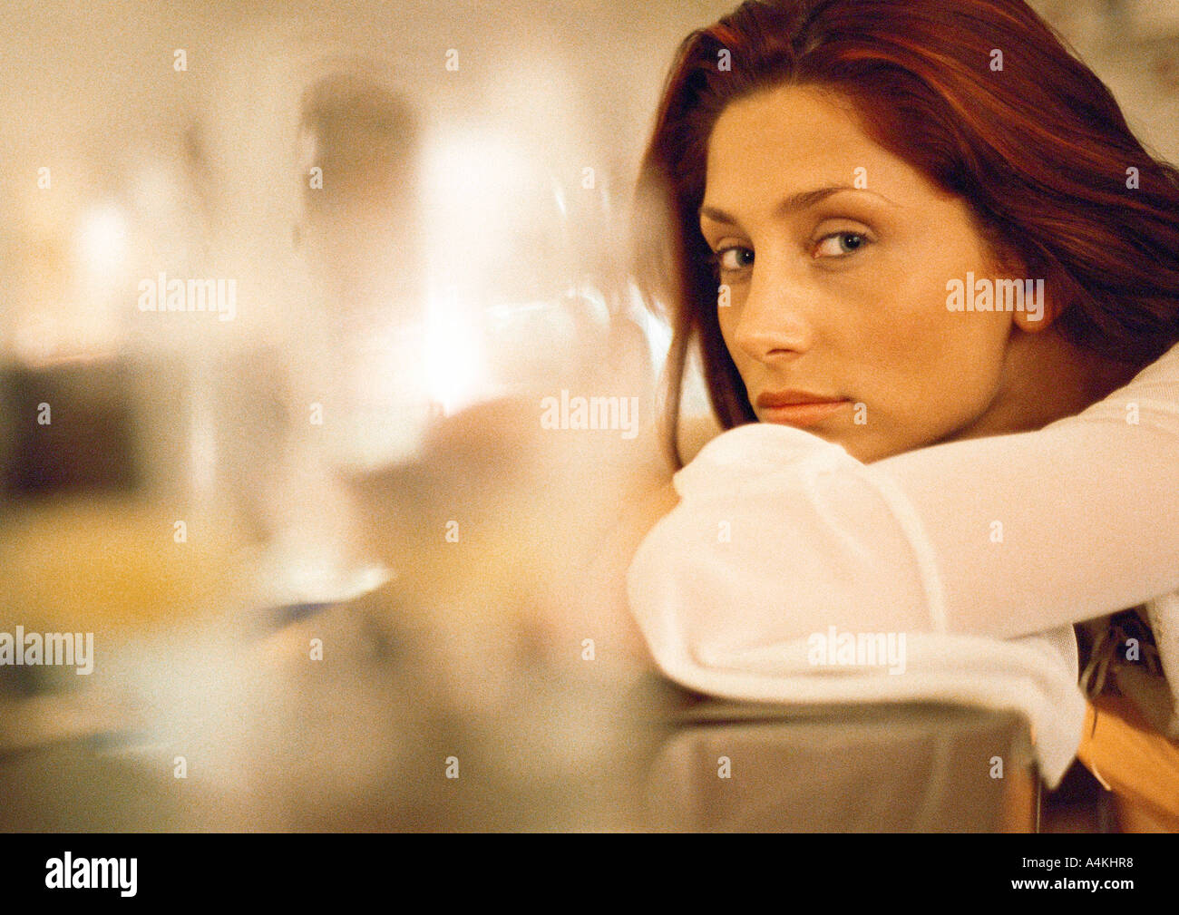 Woman leaning on arm, looking at camera Stock Photo - Alamy