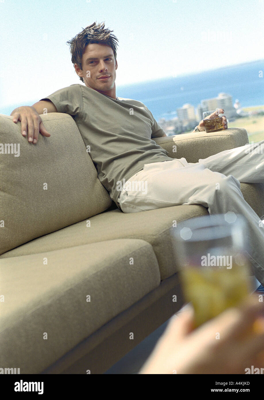Man slouching on sofa hi-res stock photography and images - Alamy