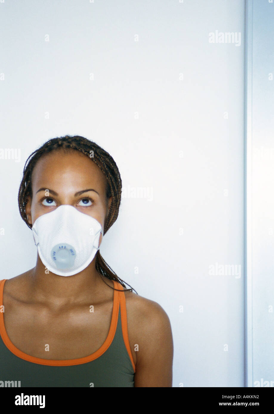 Woman wearing white dust mask over nose and mouth, portrait Stock Photo ...
