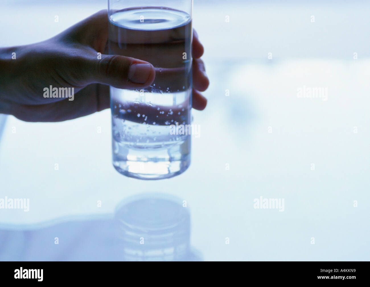 Hand holding glass filled with water, close-up Stock Photo - Alamy