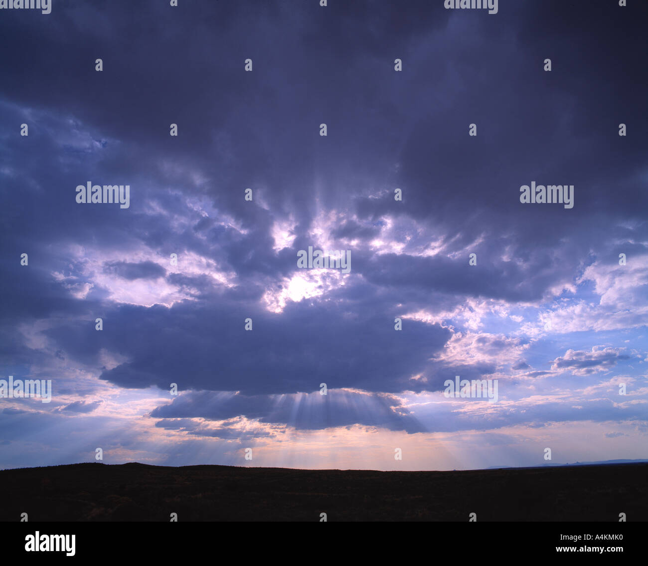 Clouds with sun rays shining through Stock Photo - Alamy