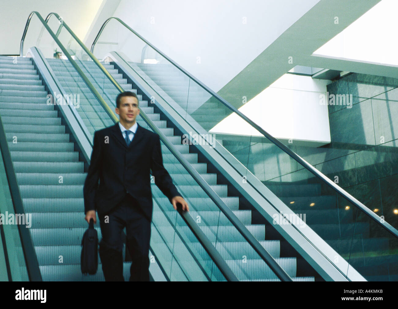 Descending escalator, man hi-res stock photography and images - Alamy