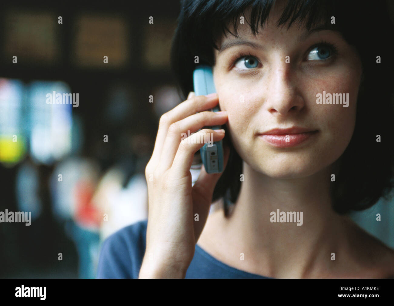 Blue haired woman looking at her cell phone hi-res stock photography ...