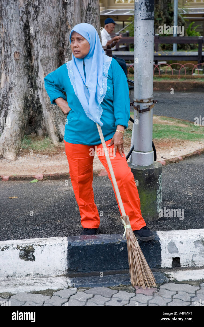 A colourfully dressed female street sweeper in Malacca Stock Photo - Alamy