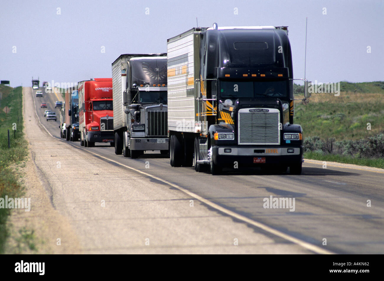 Long haul trucks drive in a line on Interstate 84 east of Boise Idaho ...