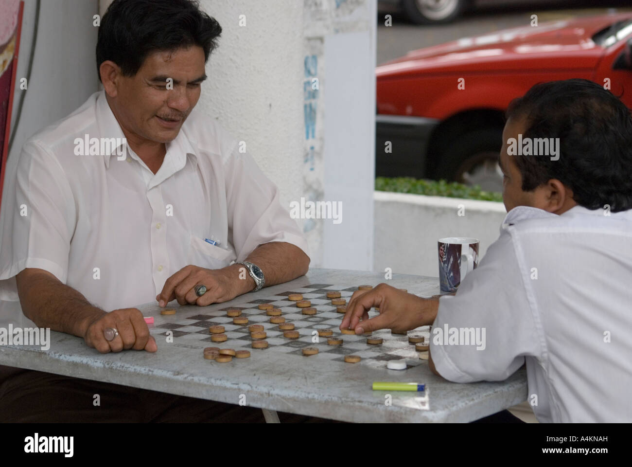 Two taxi drivers playing draughts while waiting for a fare Kuala Lumpur ...
