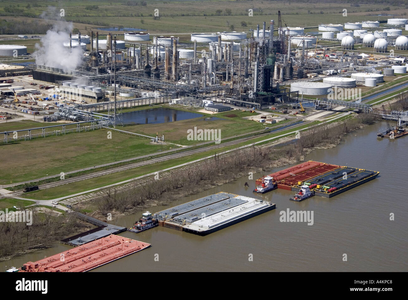 Aerial of refinery and tug boats along the Mississippi River near New ...