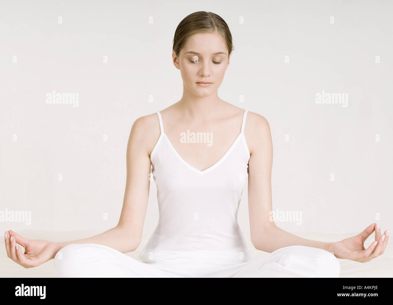 Woman sitting indian style meditating hi-res stock photography and ...