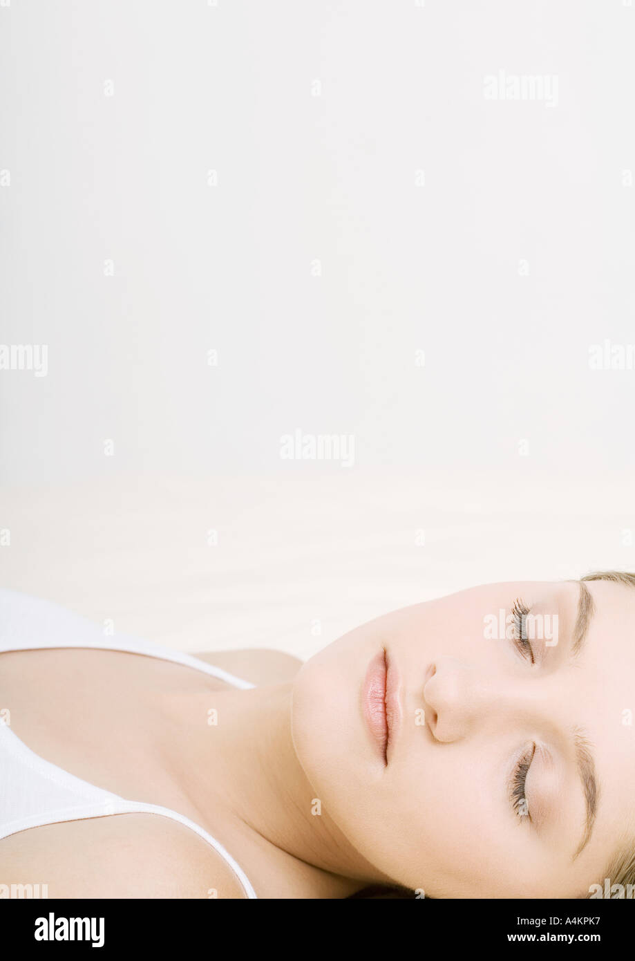 Woman lying down with eyes closed, close-up Stock Photo - Alamy