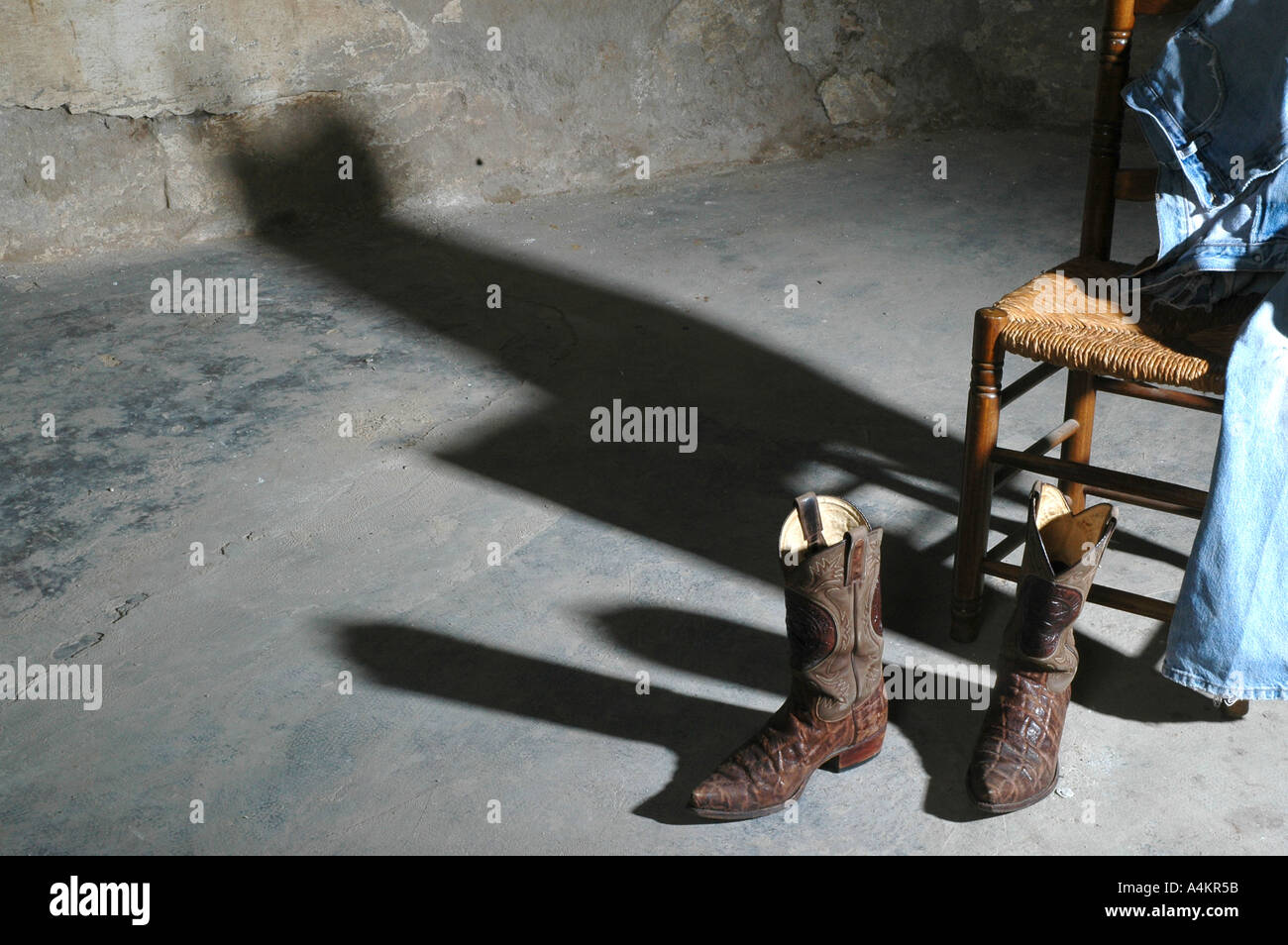 Chair with denim jeans and cowboy boots Stock Photo - Alamy