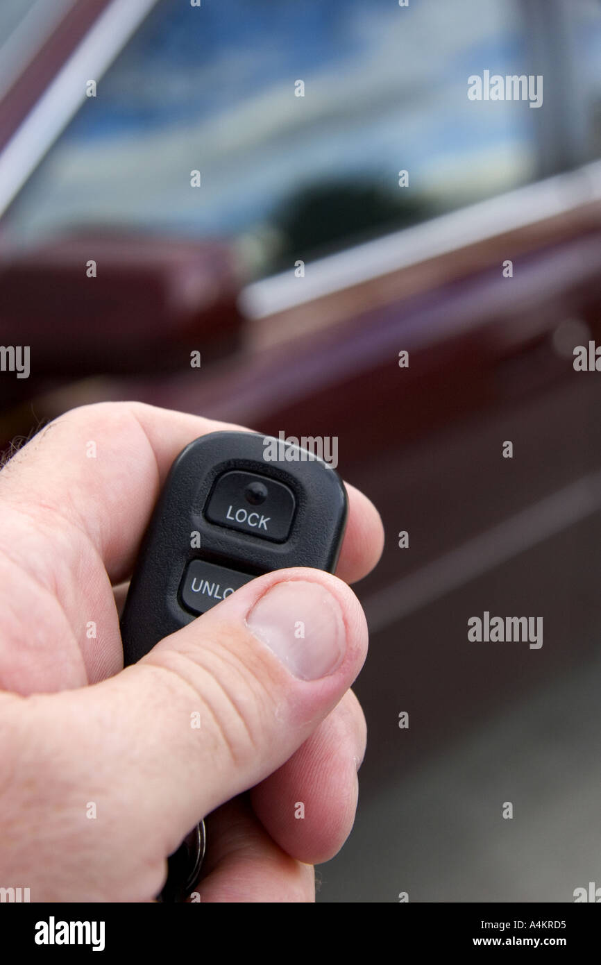 Person using a remote system to lock and unlock car doors Stock Photo ...