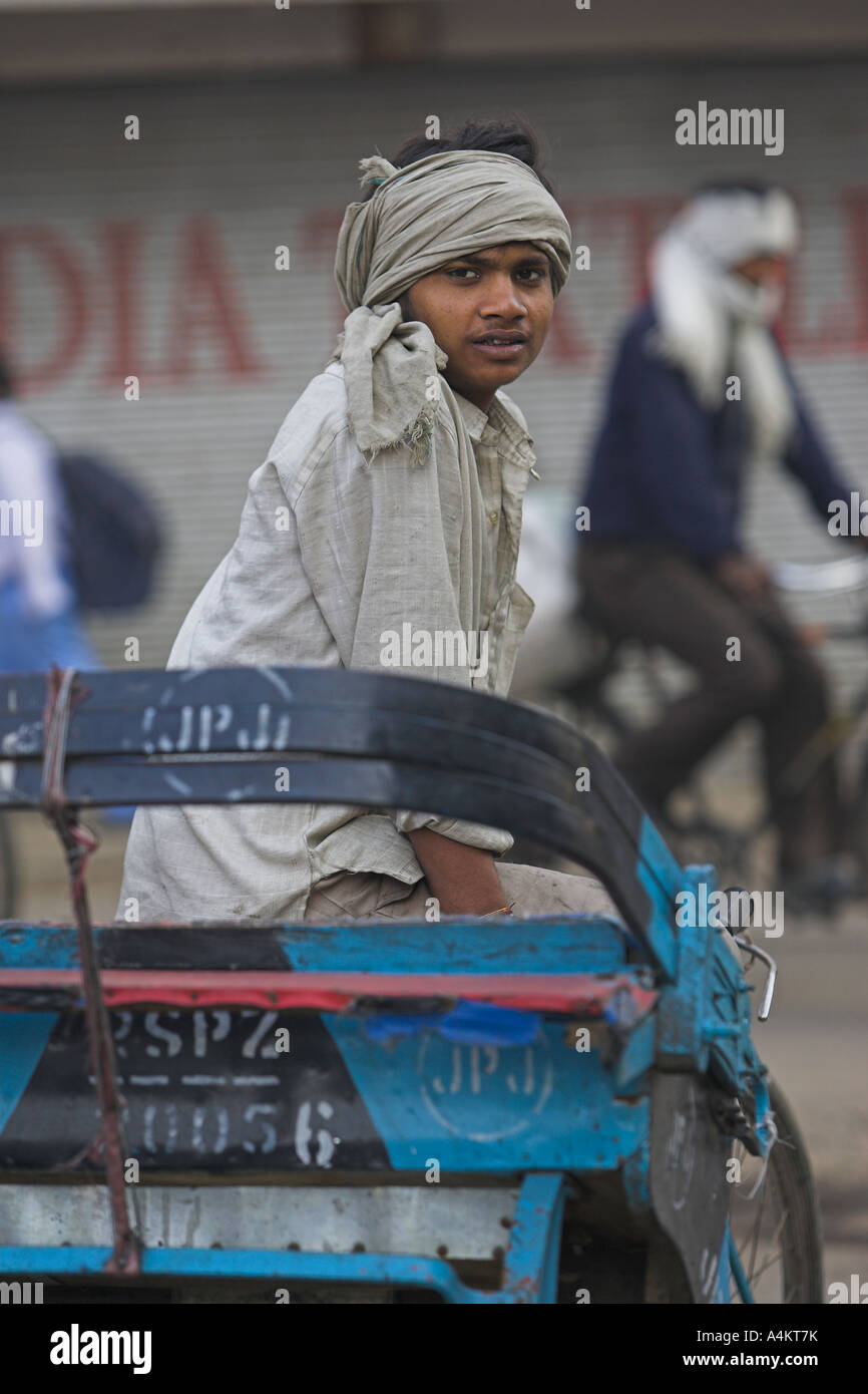 A young cycle rickshaw rider waits for his passengers, India Stock ...