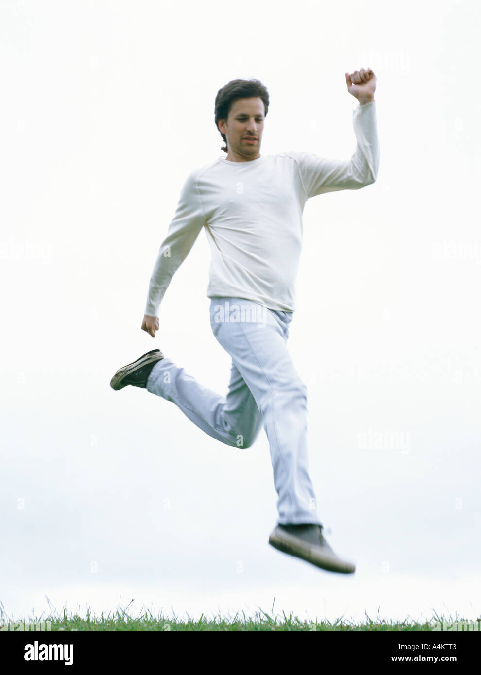 Man jumping, in mid-air, full length Stock Photo - Alamy