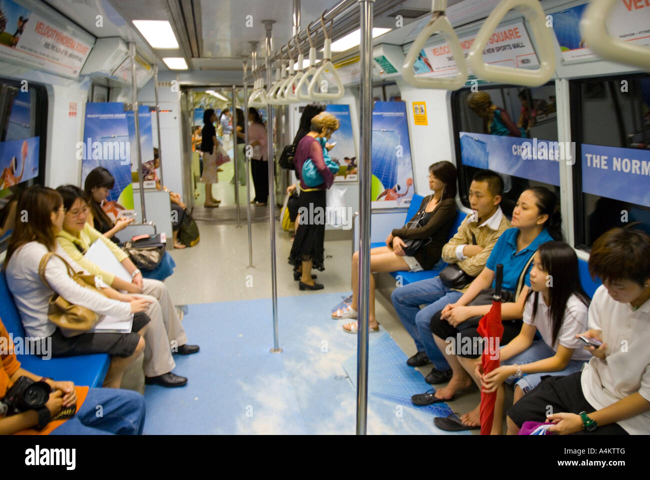 Commuters on the Singapore urban train system Stock Photo - Alamy