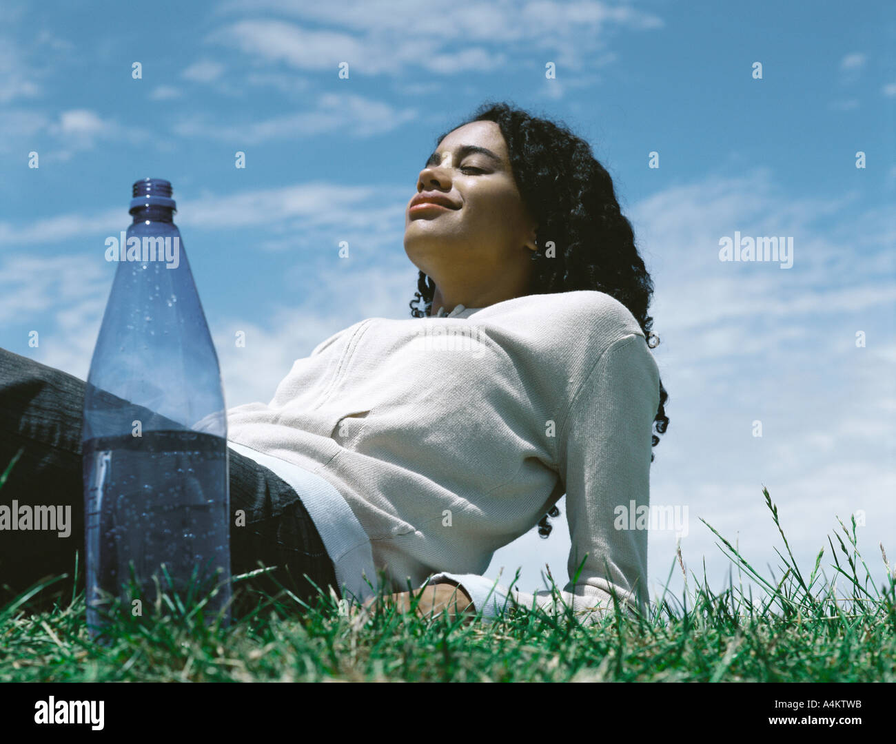 Young women sunbathing on grass hi-res stock photography and images - Alamy