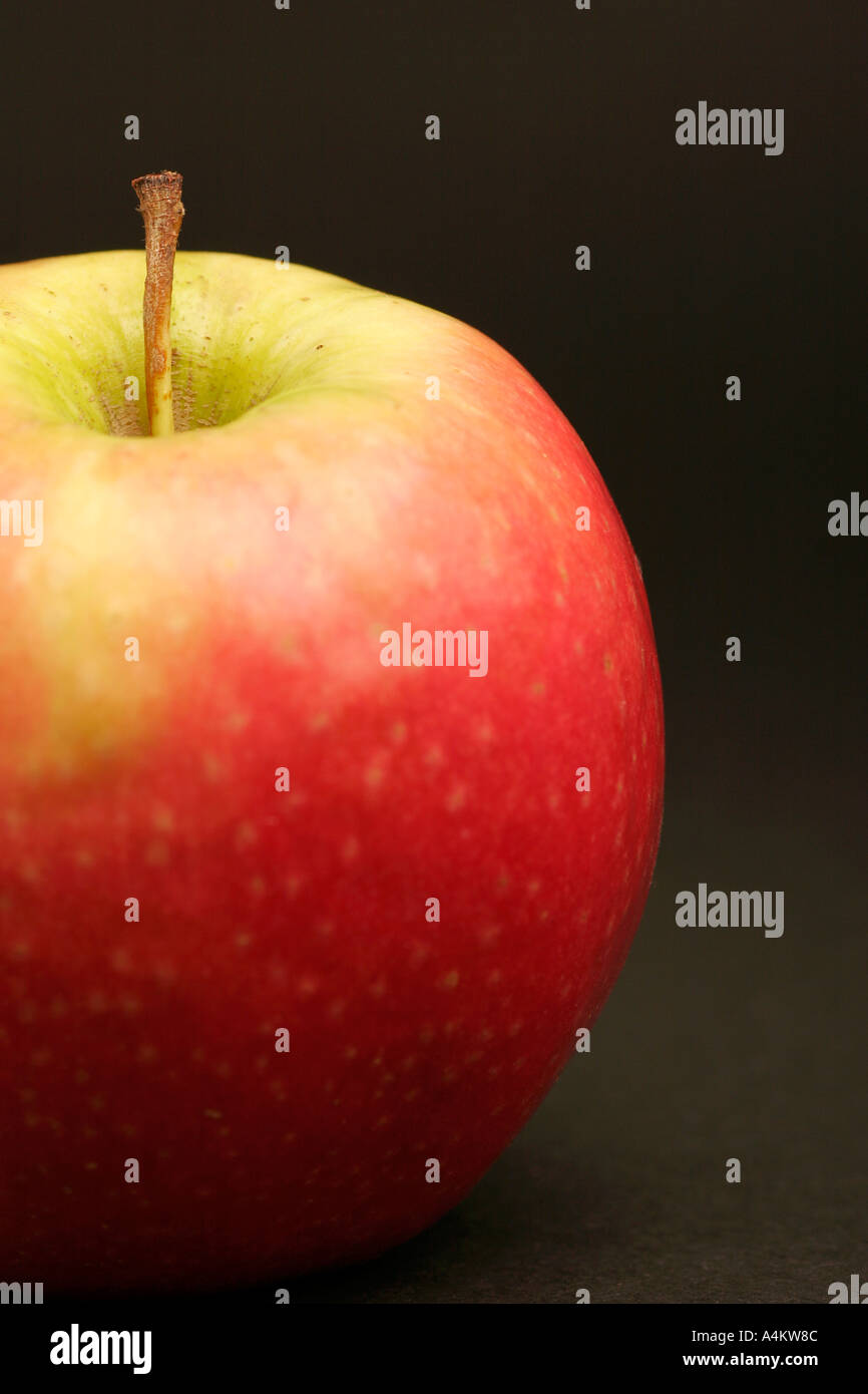 Single Pink Lady apple on black background Stock Photo - Alamy